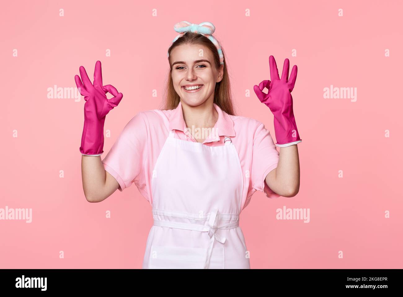 woman in rubber gloves and cleaner apron showing ok Stock Photo - Alamy