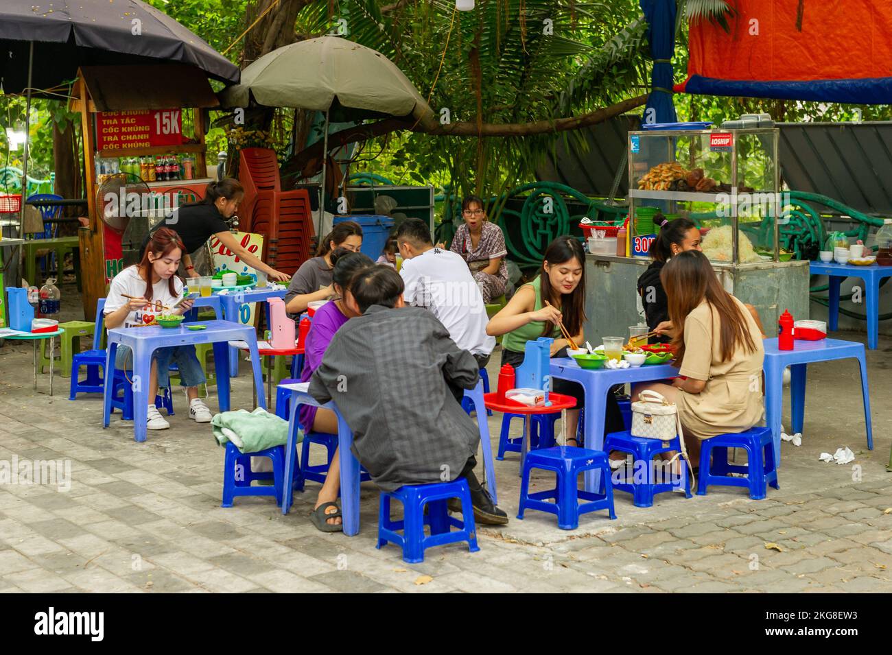 Enjoying dinner time street food in Hanoi, Vietnam Stock Photo - Alamy