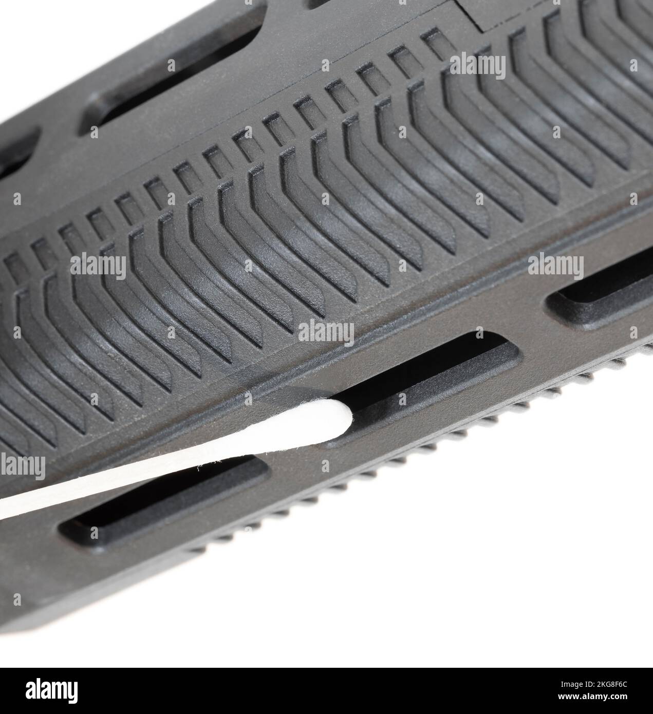 Bottom of an AR-15 handguard being cleaned with a cotton swab Stock ...