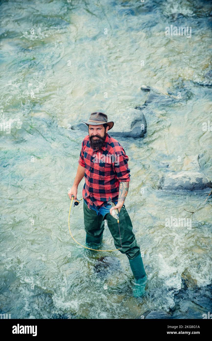 Fisherman caught a fish. Man fishing on river. Fisher man in water ...