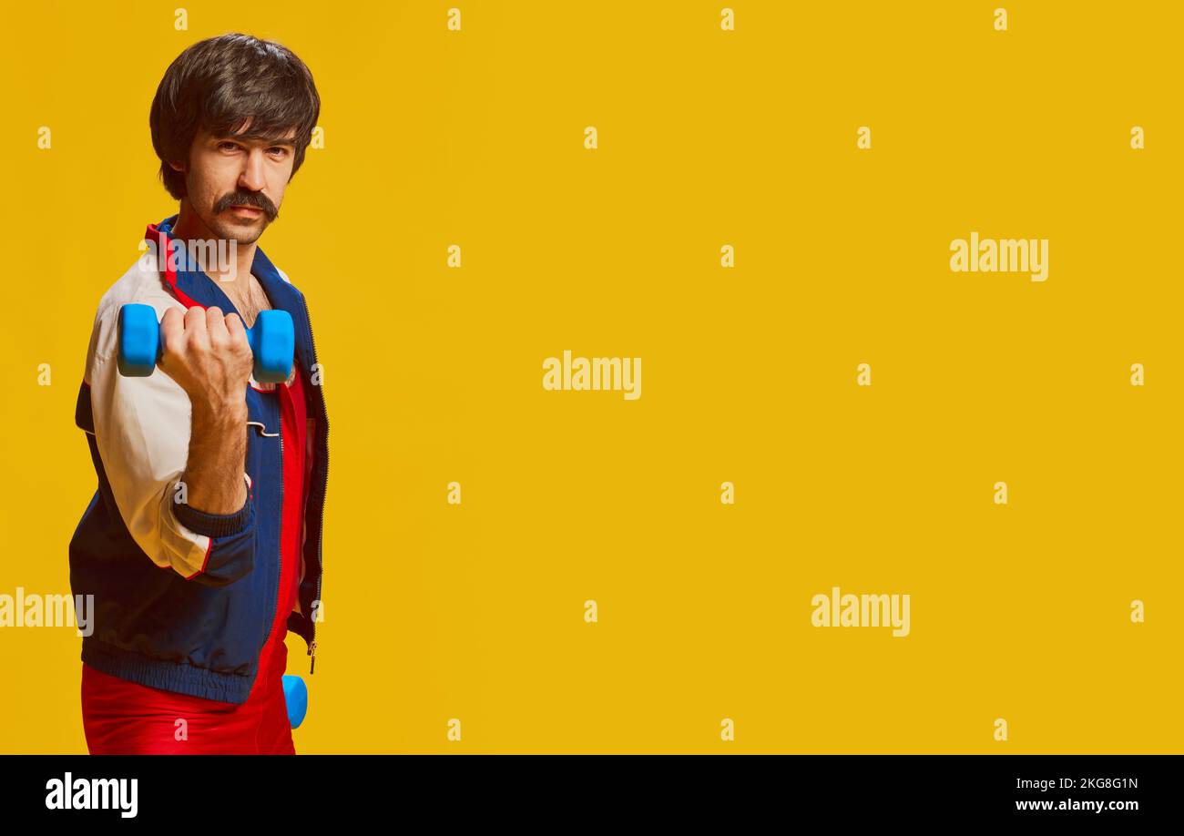 Portrait of stylish man with moustache posing in vintage sportswear ...