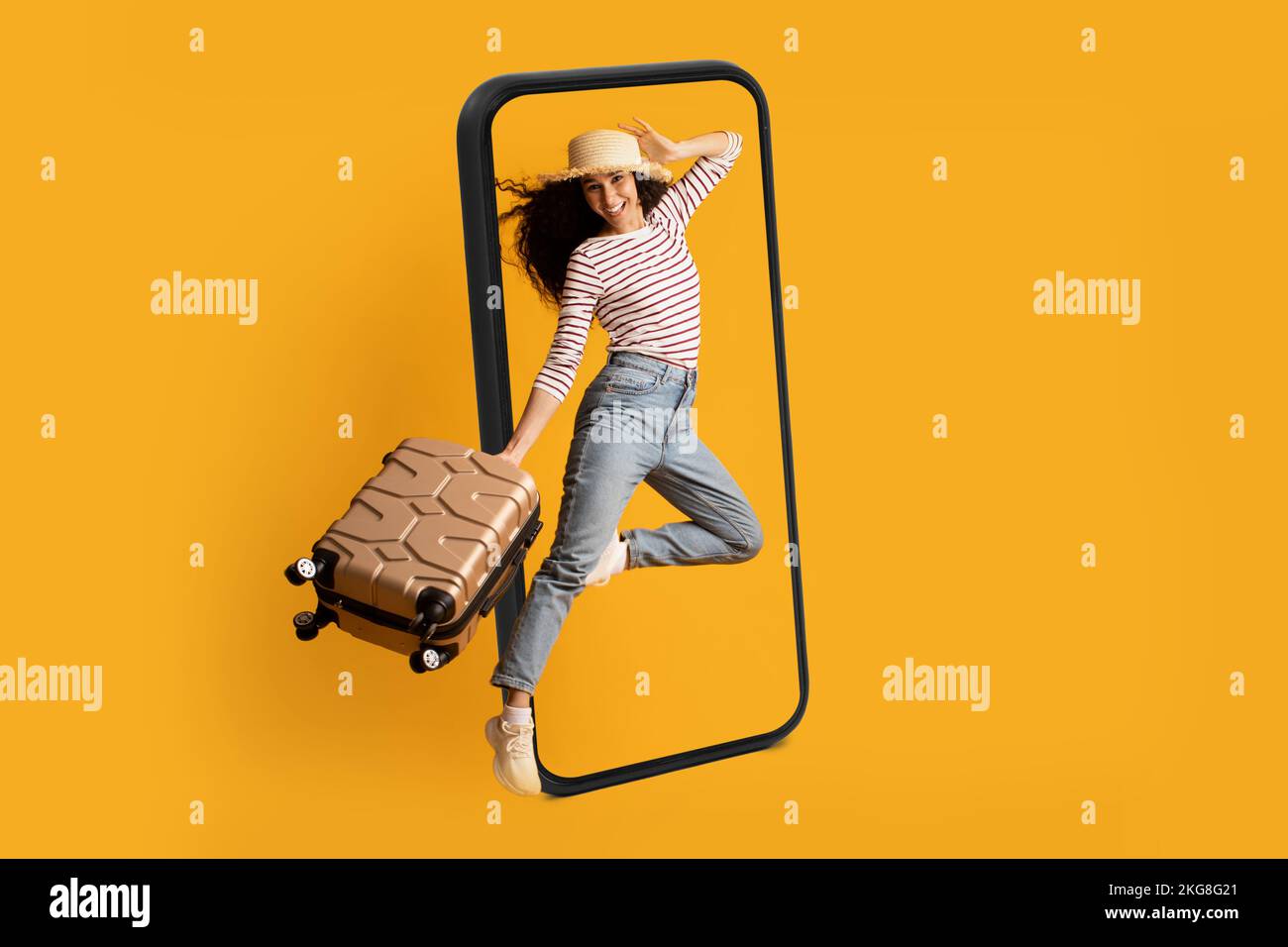 Smiling excited young arab lady tourist in hat with suitcase jumping ...