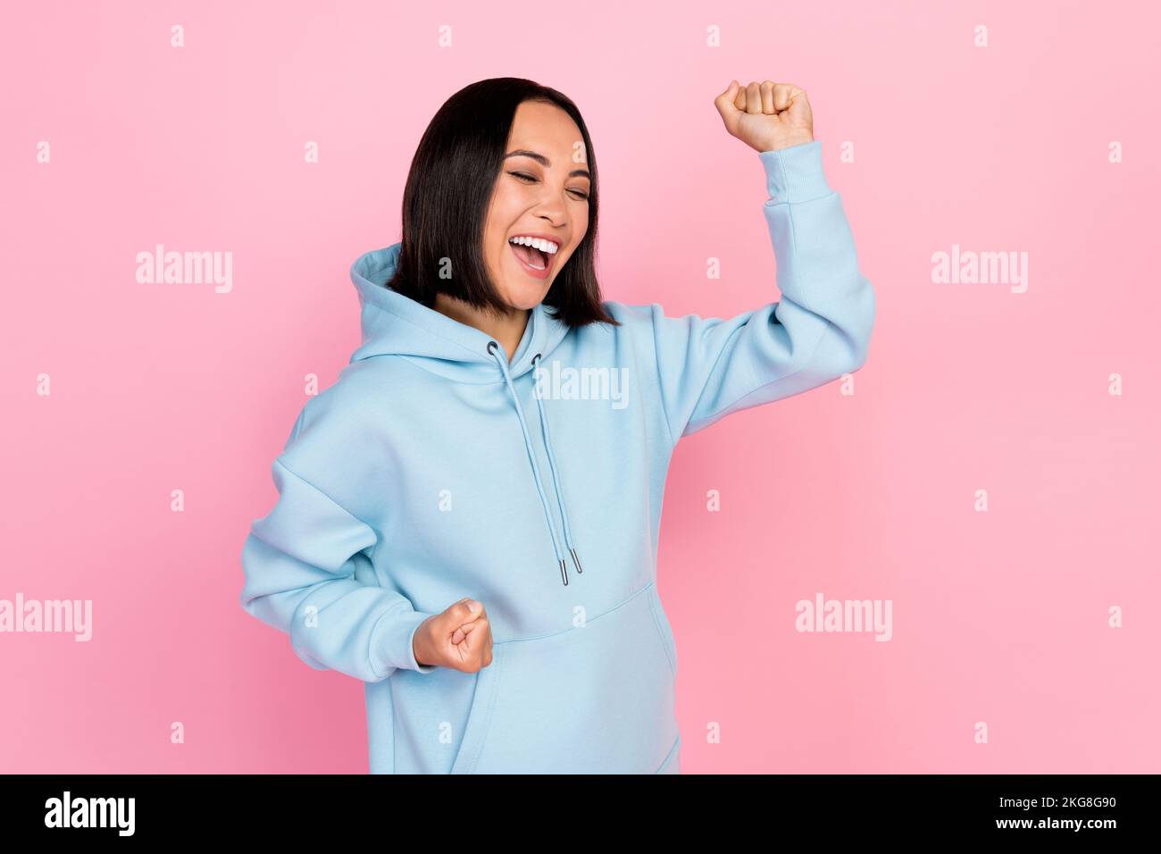 Photo portrait of pretty young woman raise fists celebrate victory ...