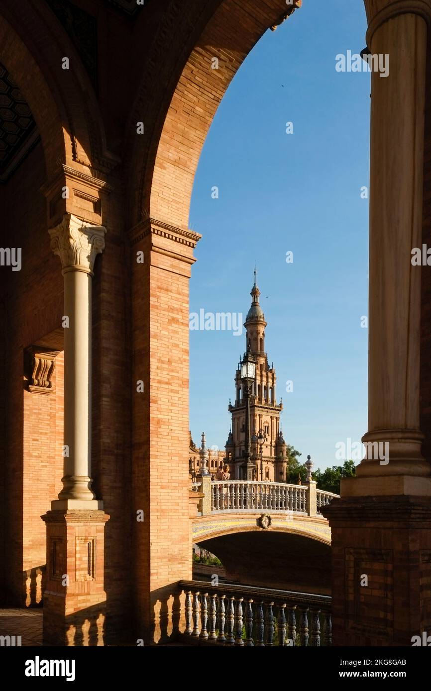 Spain, Seville, Arch bridge and bell tower at Plaza de Espagna Stock ...