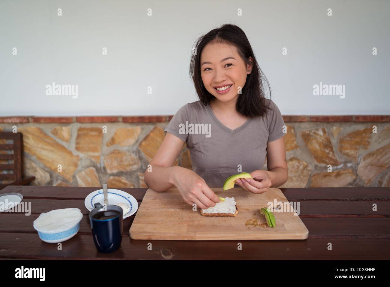 An East Asian woman making avocado toast Stock Photo - Alamy