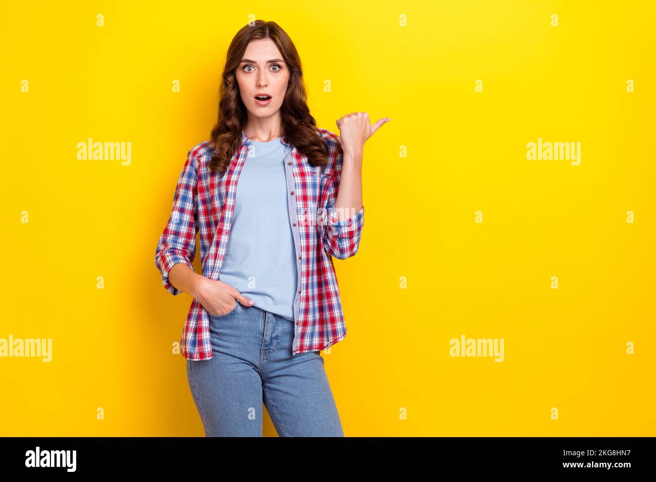 Photo of cute impressed lady wear plaid shirt open mouth pointing thumb ...