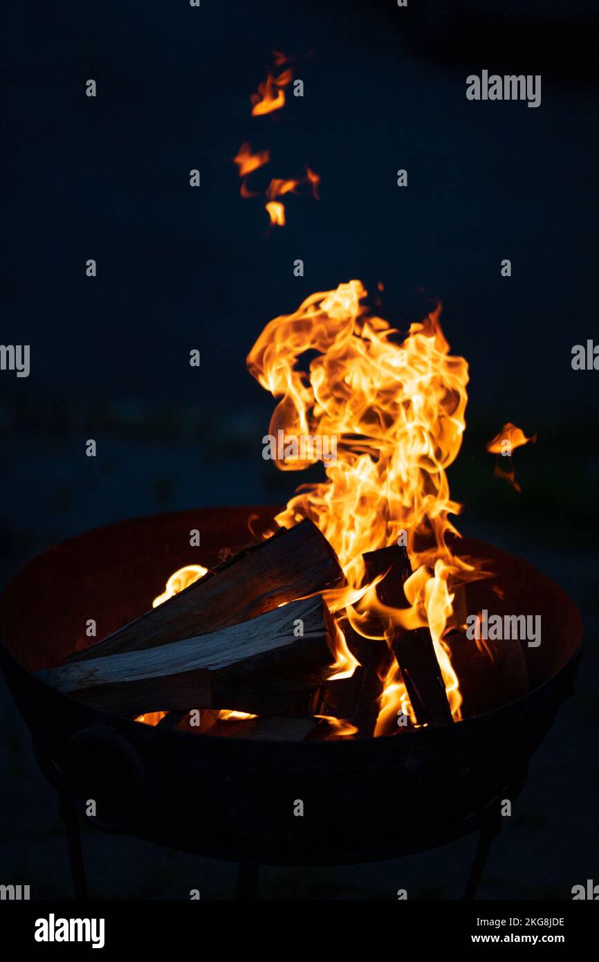 A vertical shot of flaming logs on a bonfire during nighttime Stock ...