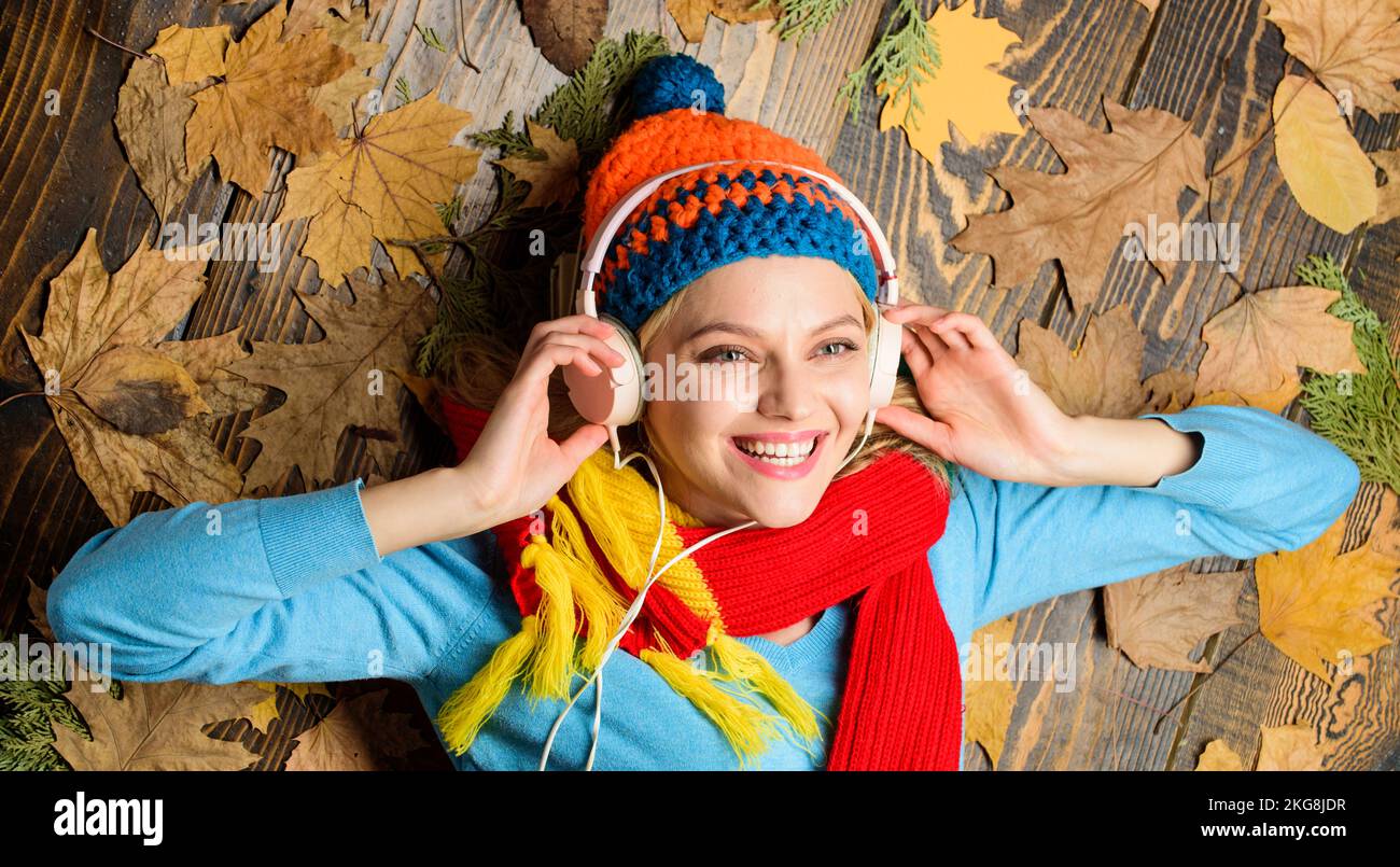Girl cheerful face lay on wooden background with leaves top view ...