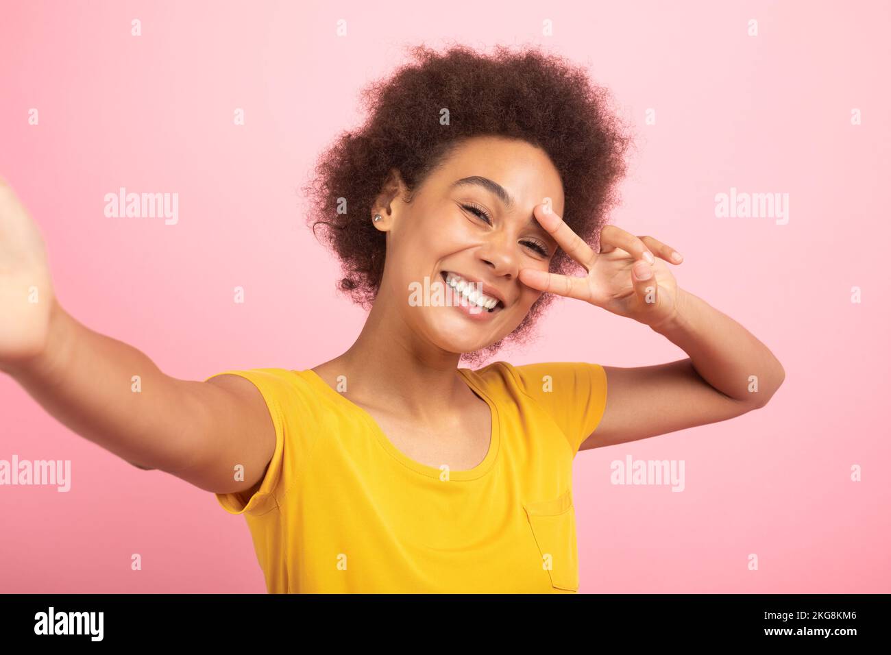 Cheerful millennial african american curly lady student in yellow t ...