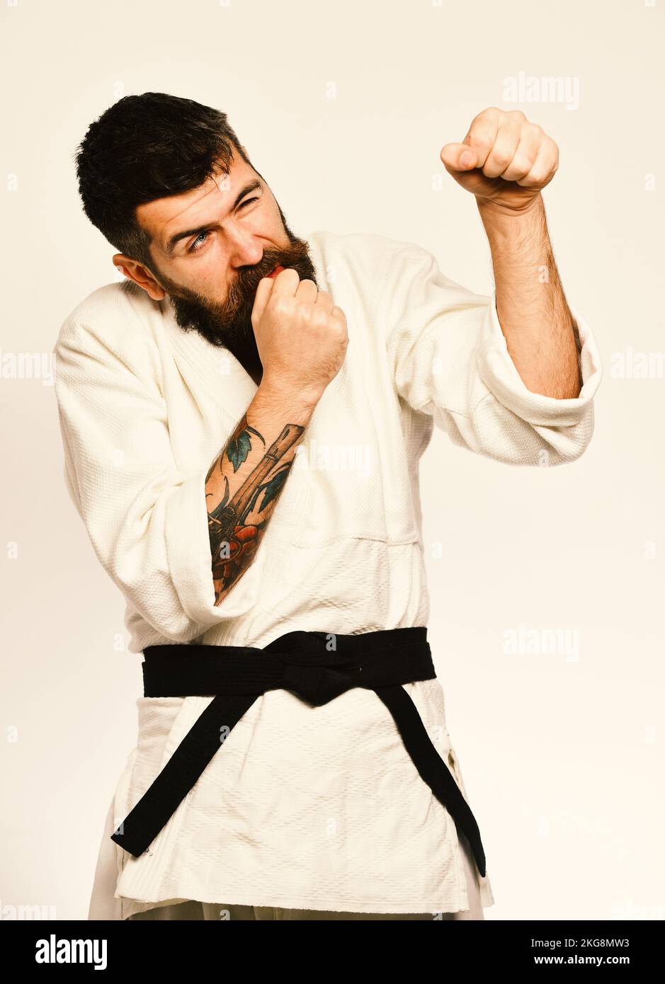 Judo master with black belt bites nails in fear Stock Photo - Alamy