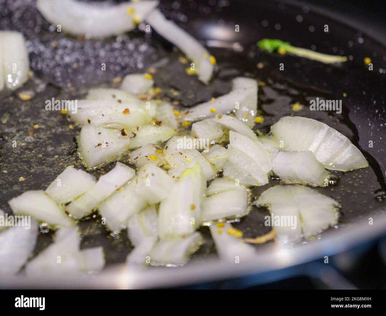 Onions are fried in a ceramic graphen black pan, pure olive oil Stock ...
