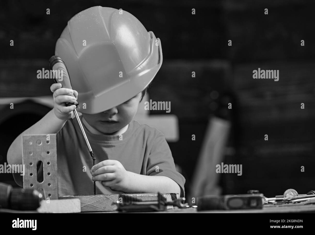 Boy play as builder or repairer, work with tools. Childhood concept ...