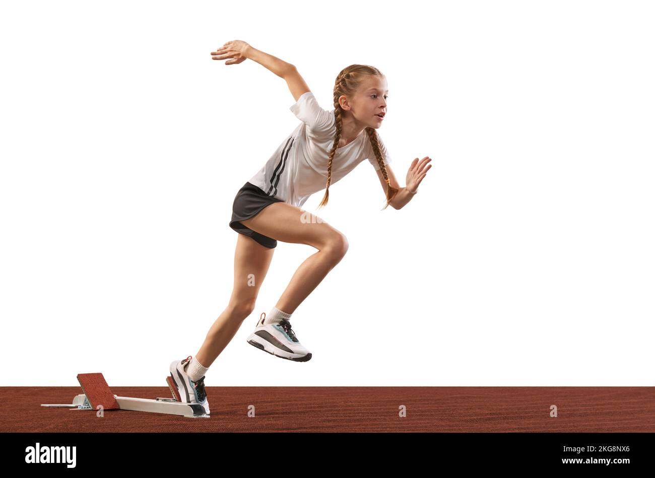 Young athlete, beginner female track runner bursting off starting block ...