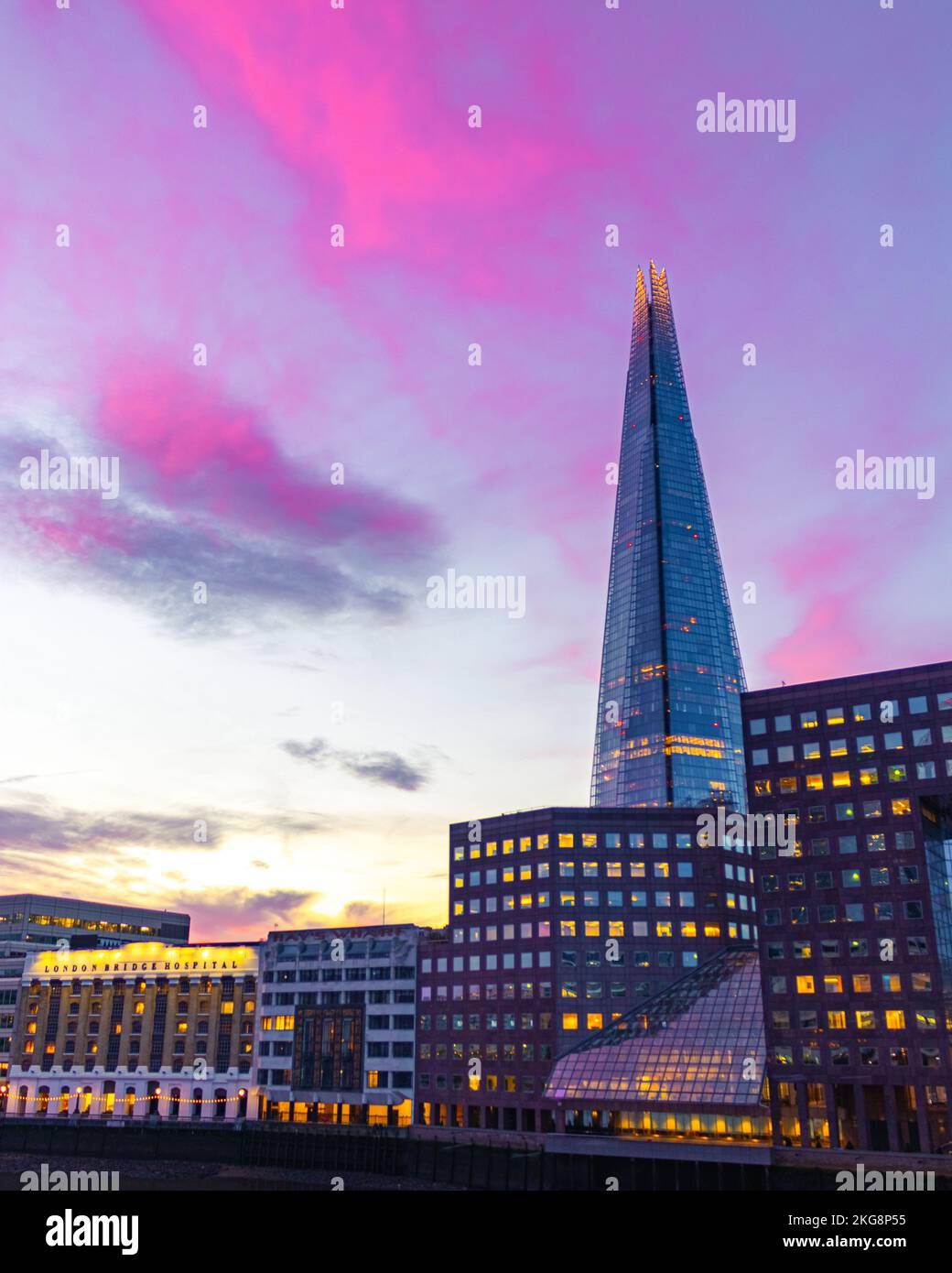 A photo of The Shard taken from London bridge with magenta clouds at ...