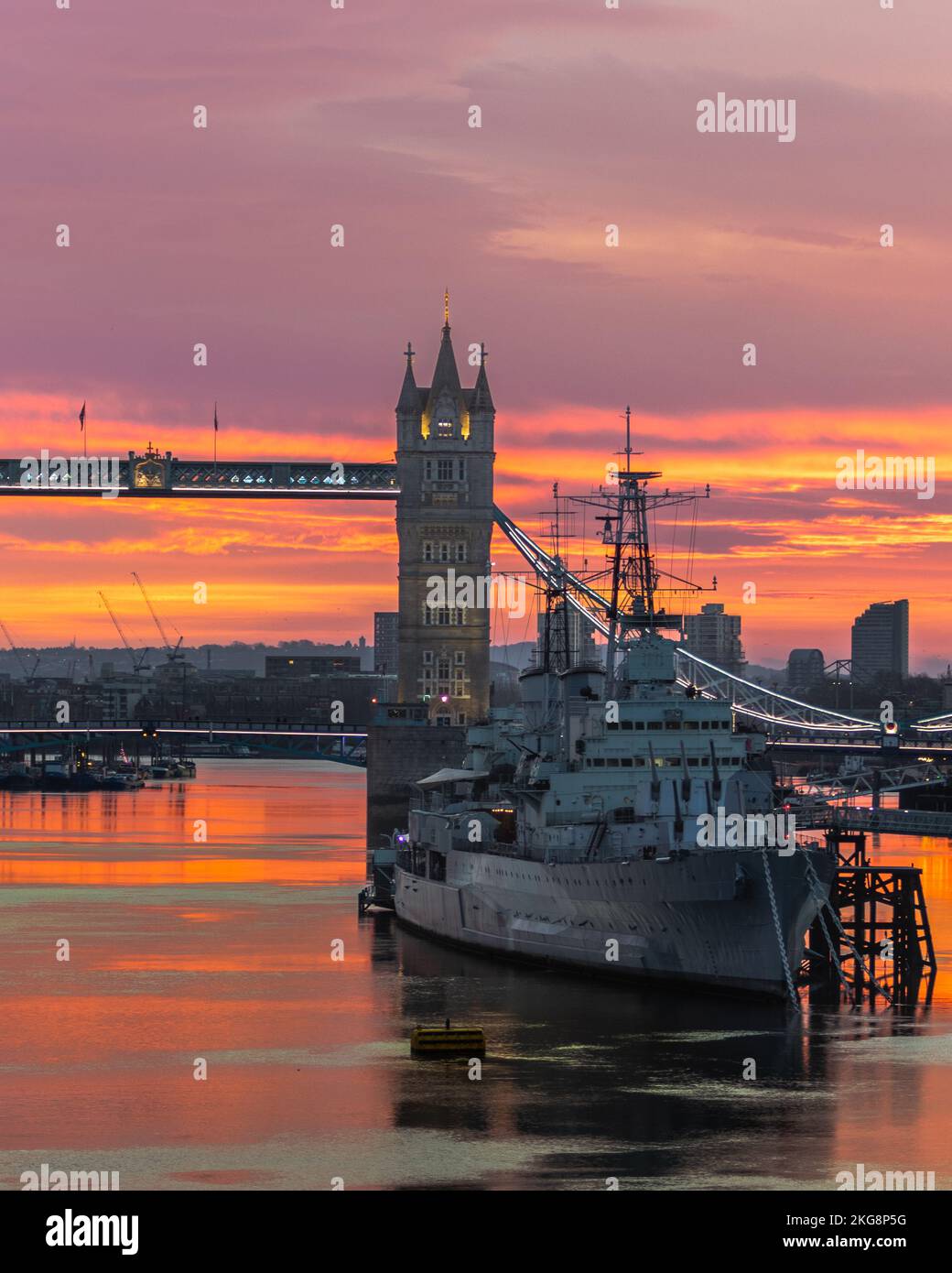 A golden sunrise over the River Thames with tower bridge and HMS Belfast, Long exposure Stock ...