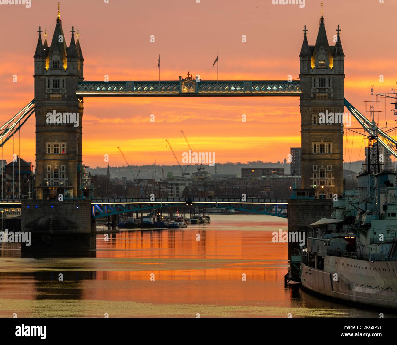 A golden sunrise over the River Thames with tower bridge and HMS Belfast, Long exposure Stock ...