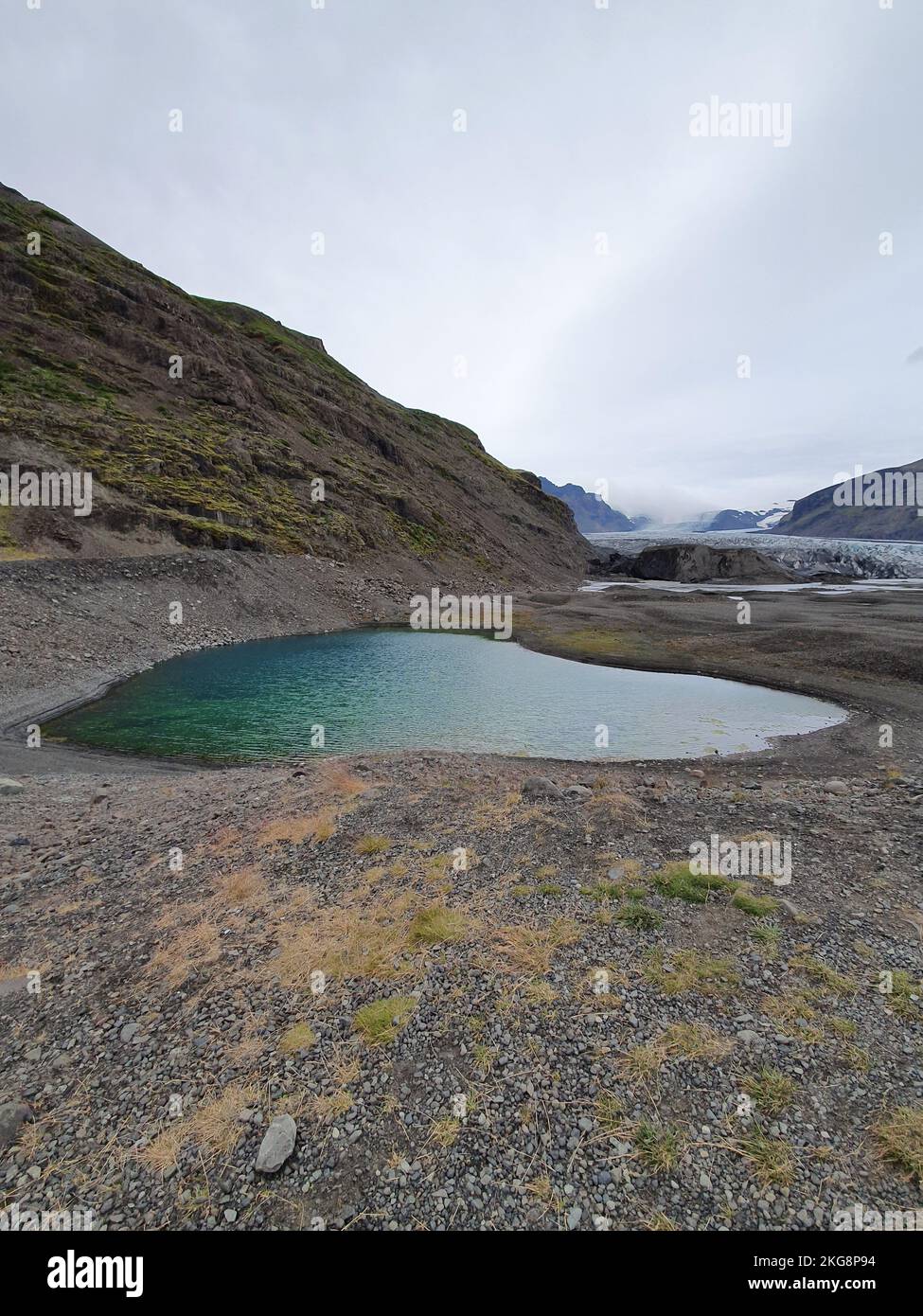 A vertical of a puddle in mountains on a cloudy day in Iceland Stock ...