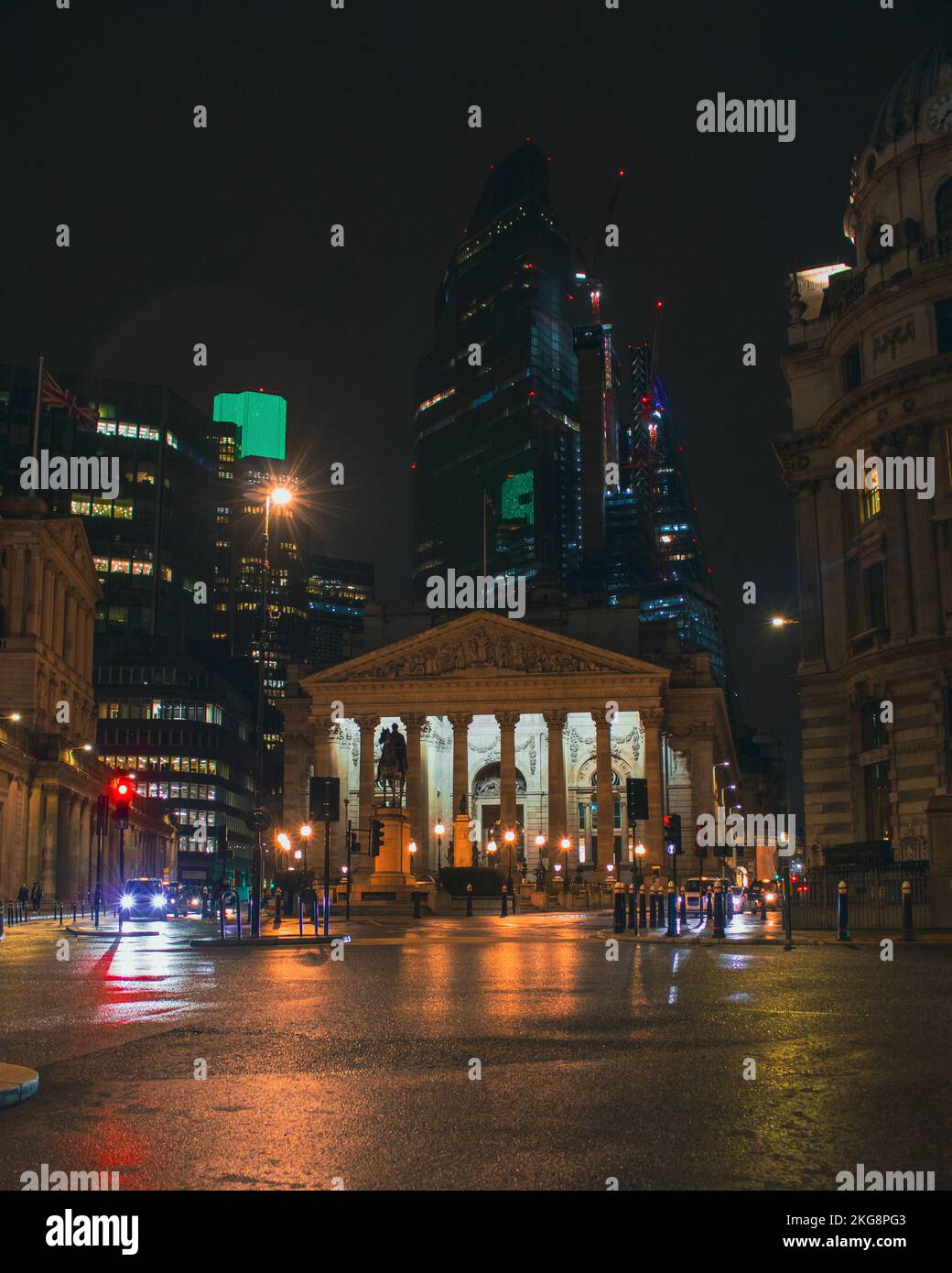 A night time photgraphy of the Royal Exchange London with sky scrapers ...