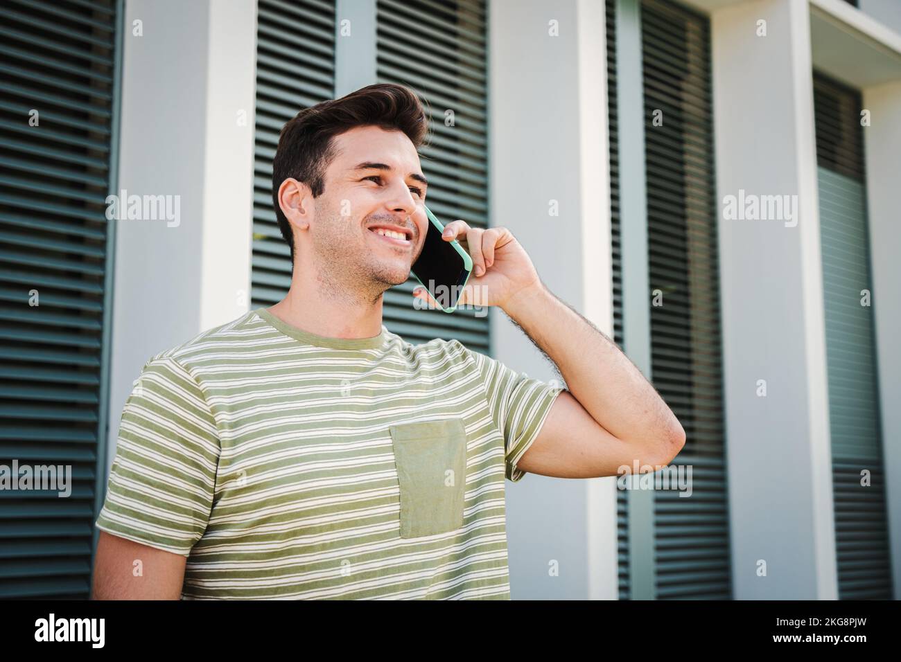 Awesome happy teenager male calling a friend using an smart phone ...