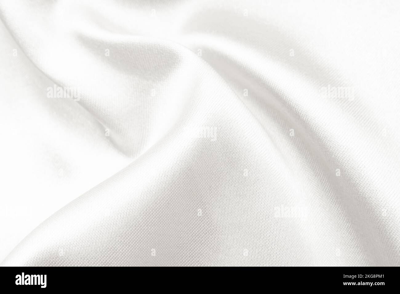 The texture of a fabric made of silk or calico with waves and rumples ...