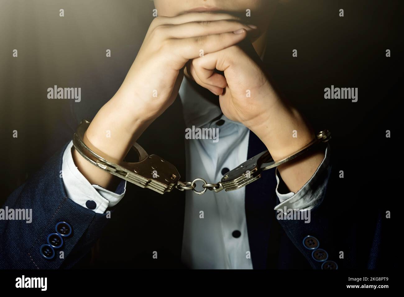 Banker or businessman in handcuffs on a black background. Criminal ...