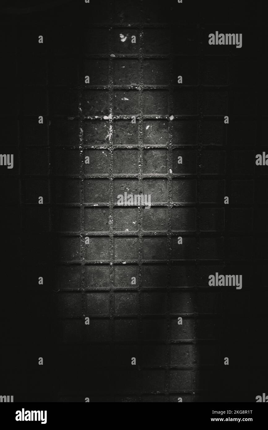 A vertical shot of the black brick background with shadow play Stock ...