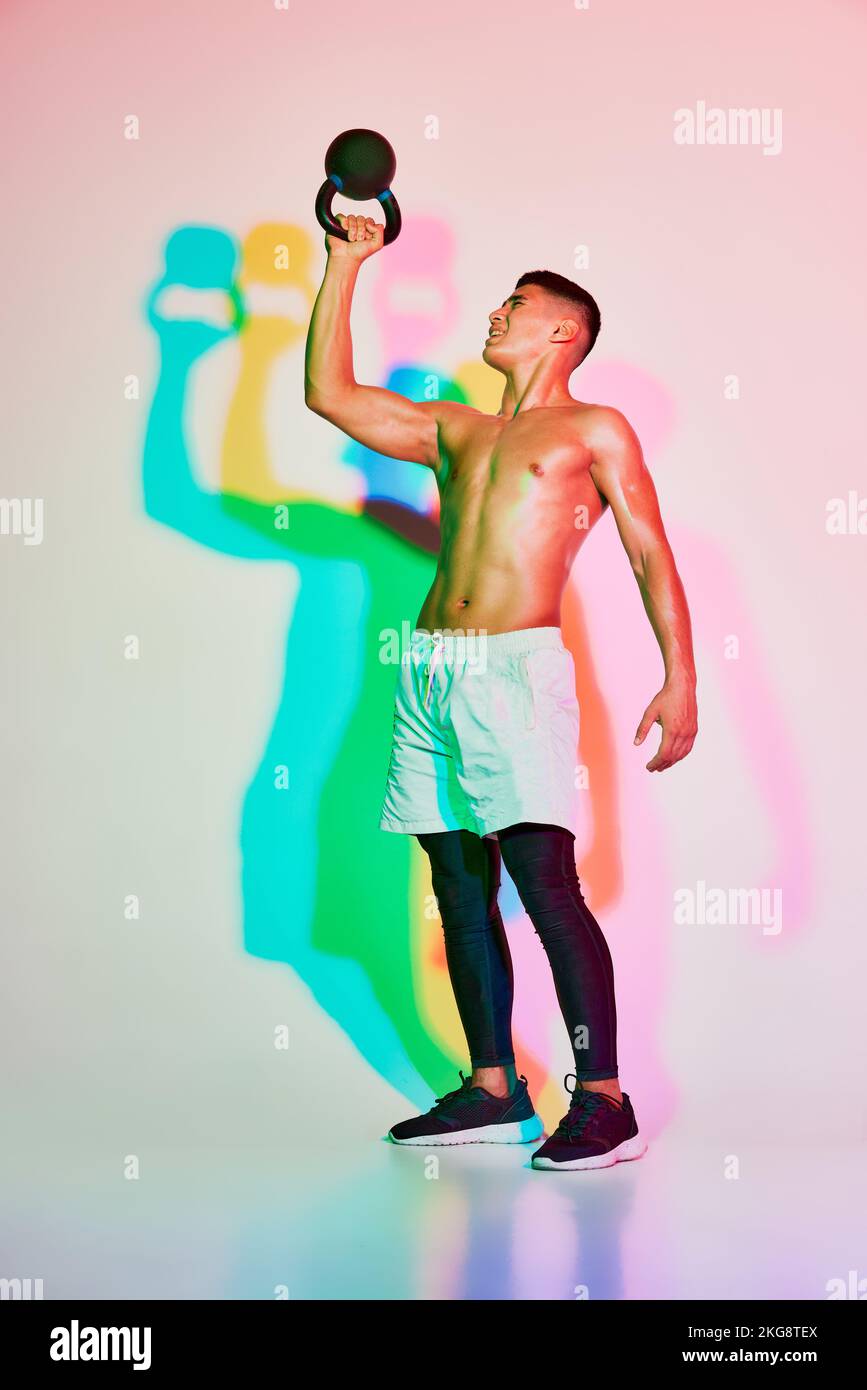 Portrait of young muscular man training, lifting weight isolated over ...