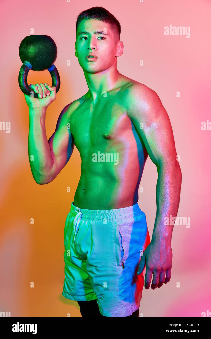 Portrait of young muscular man training, posing with weight isolated ...
