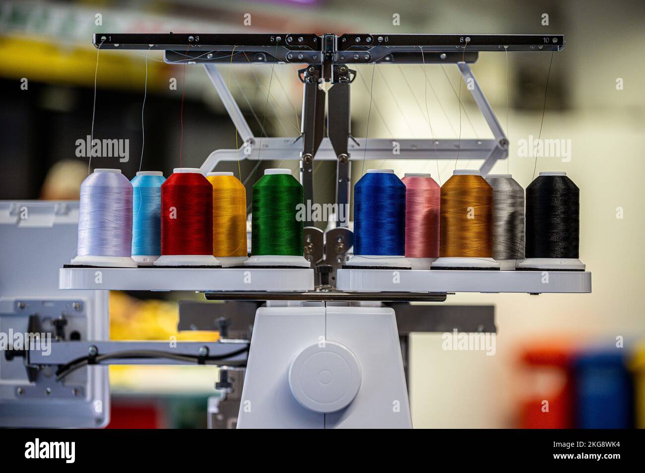 Colorful sewing threads on a professional sewing machine Stock Photo ...