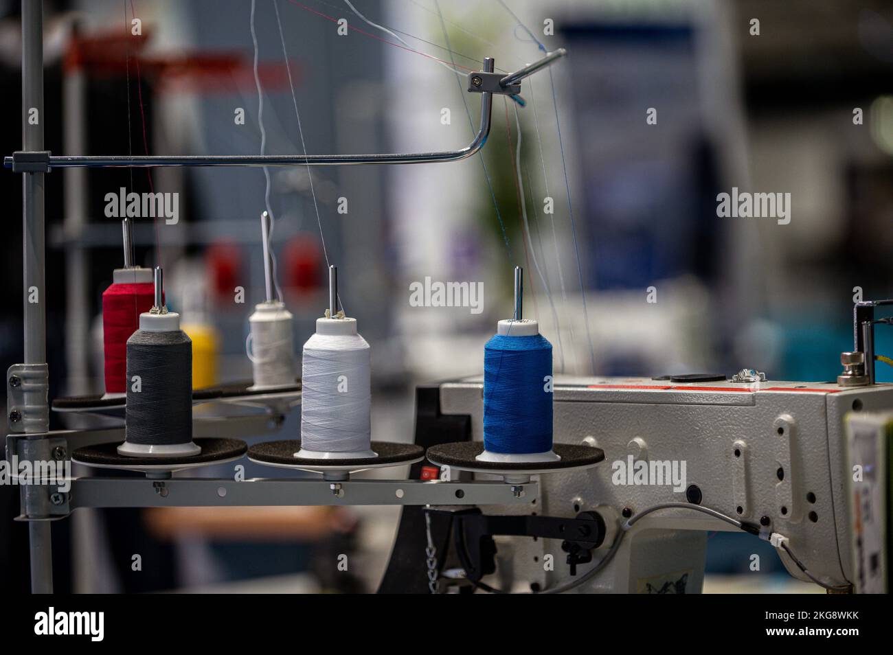 Colorful sewing threads on a professional sewing machine Stock Photo ...