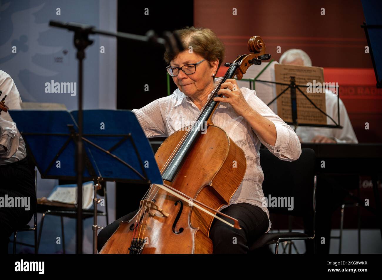 An old musician playing cello in a small orchestra performance Stock ...