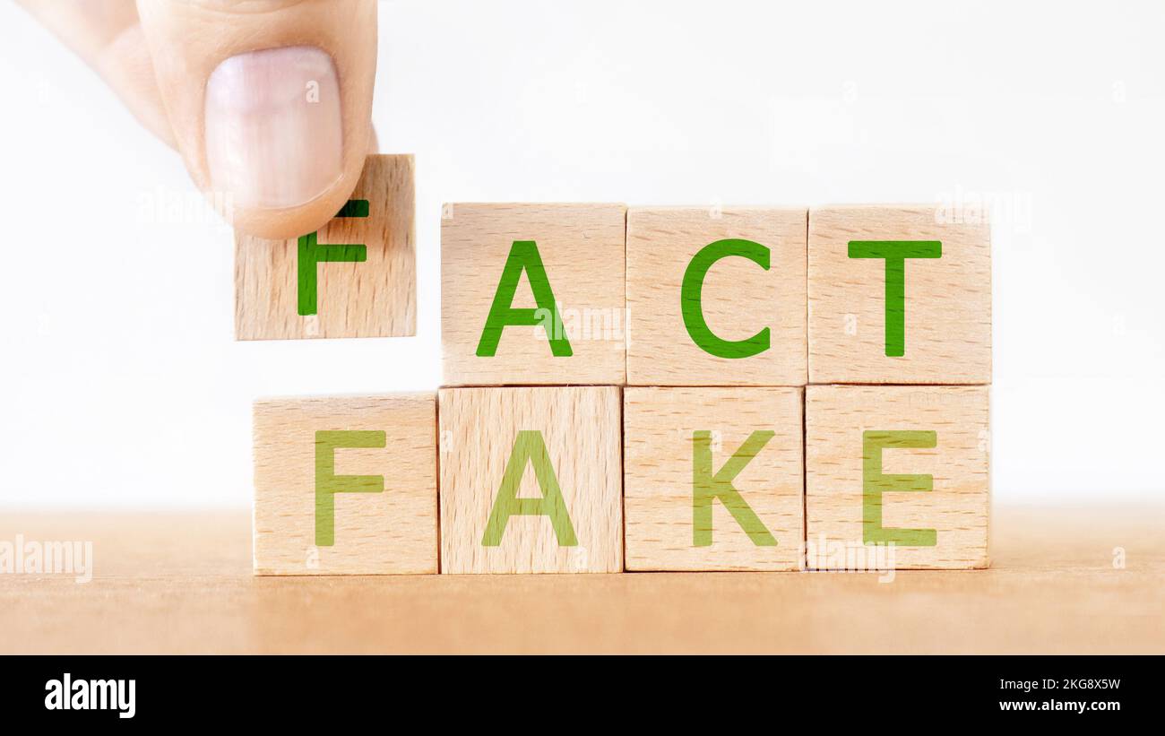A closeup of wooden cubes of Fact or Fake text Stock Photo - Alamy