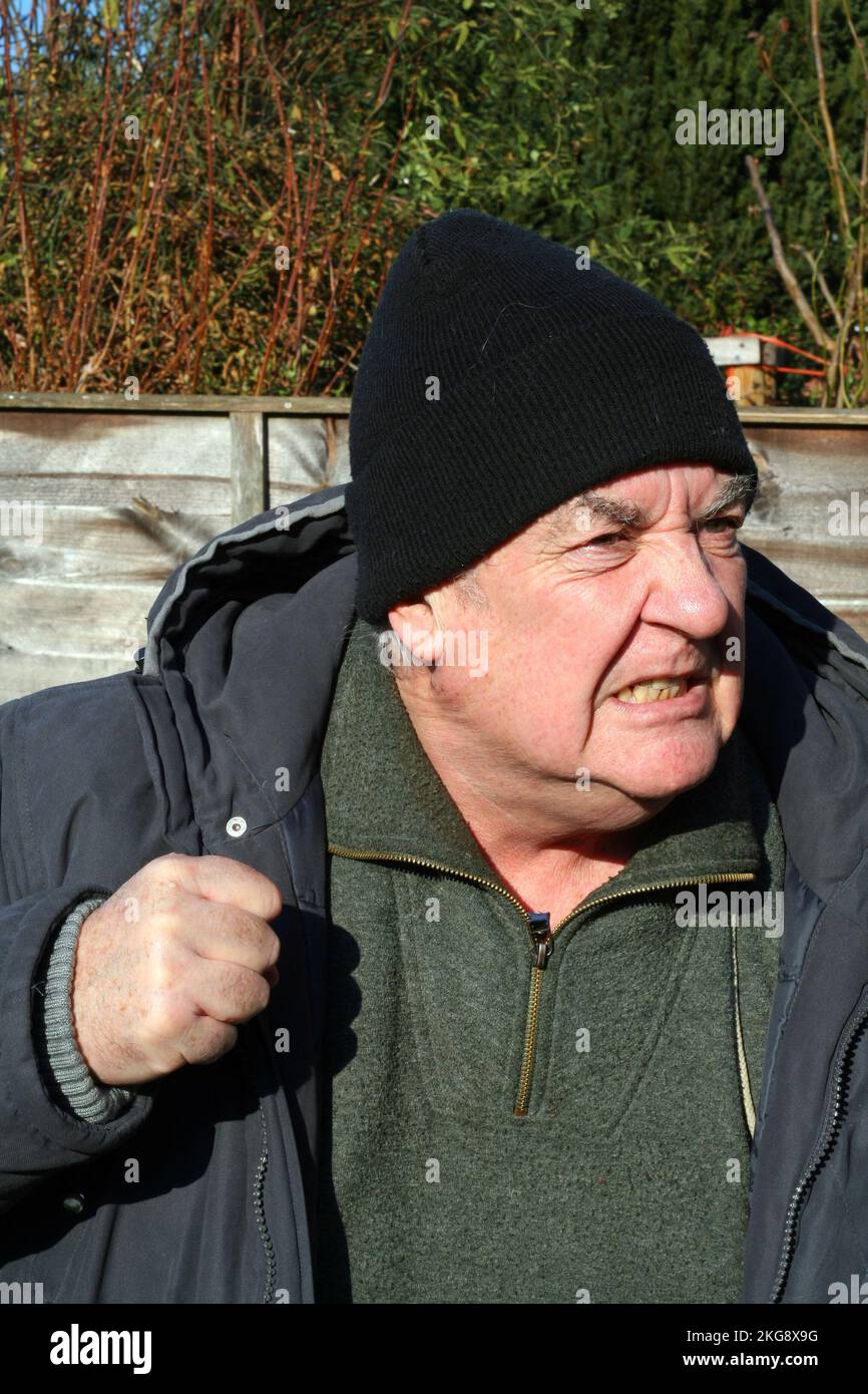 Angry old or senior man gritting his teeth and raising his fist Stock ...