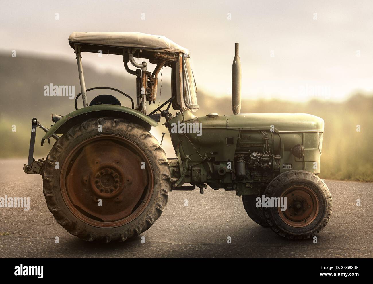 Tractor on the road in sunshine Stock Photo - Alamy