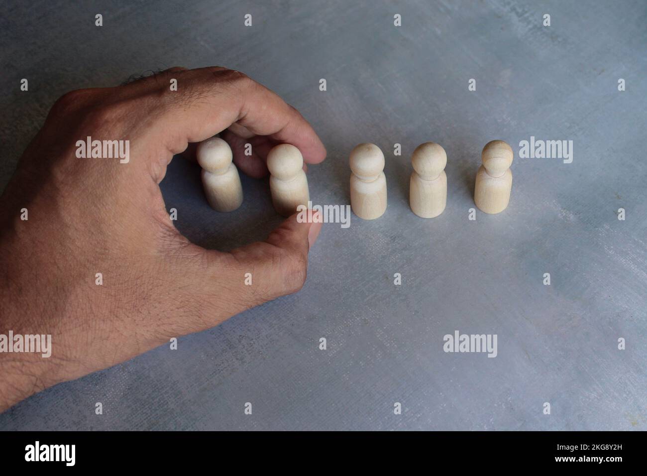 Hand separate wooden dolls. Team disbandment, separation of staff ...