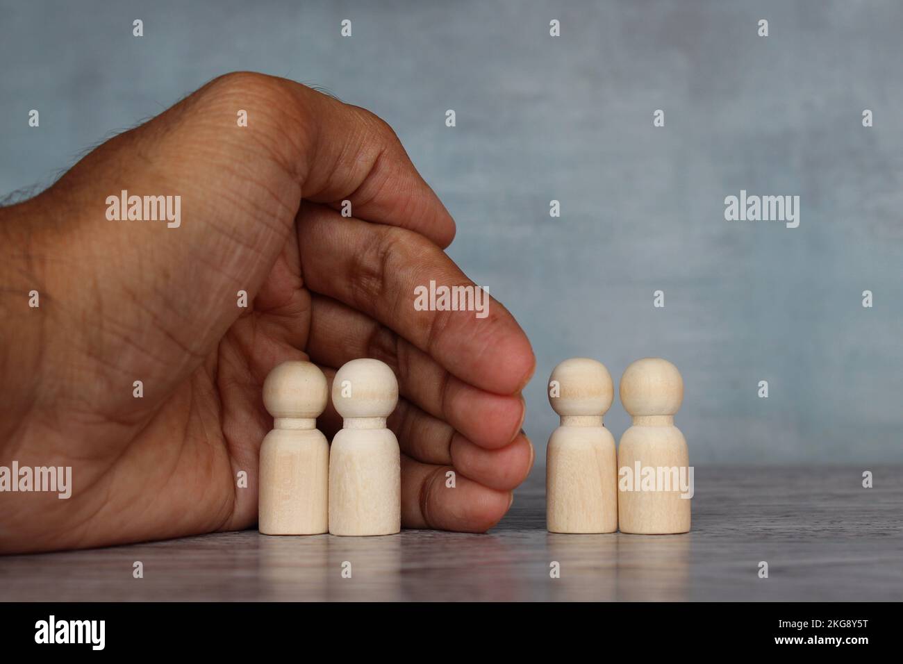 Hand separate wooden dolls. Team disbandment, separation of staff ...