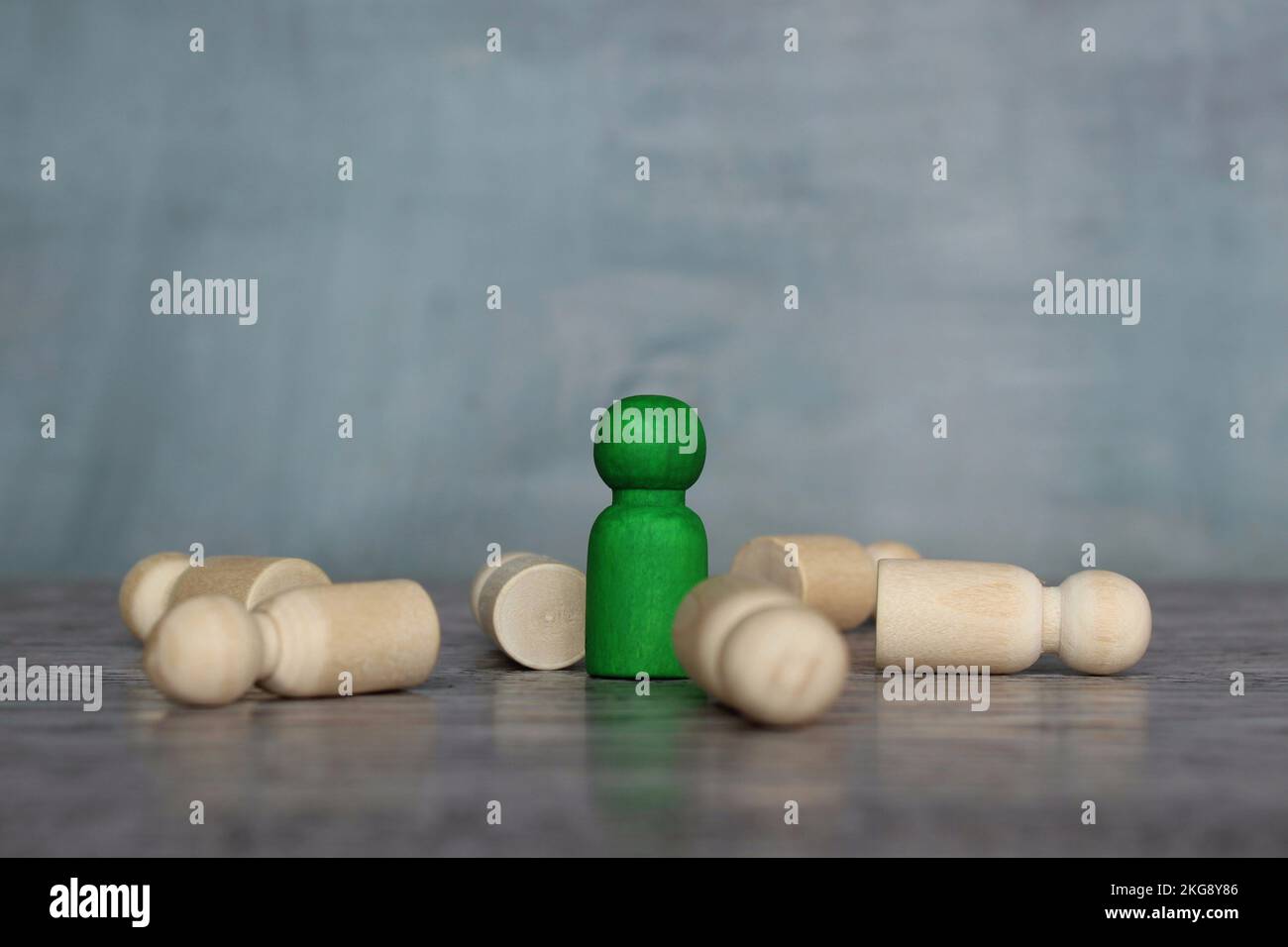 Winning, victory, success and surviving concept. Green wooden doll ...