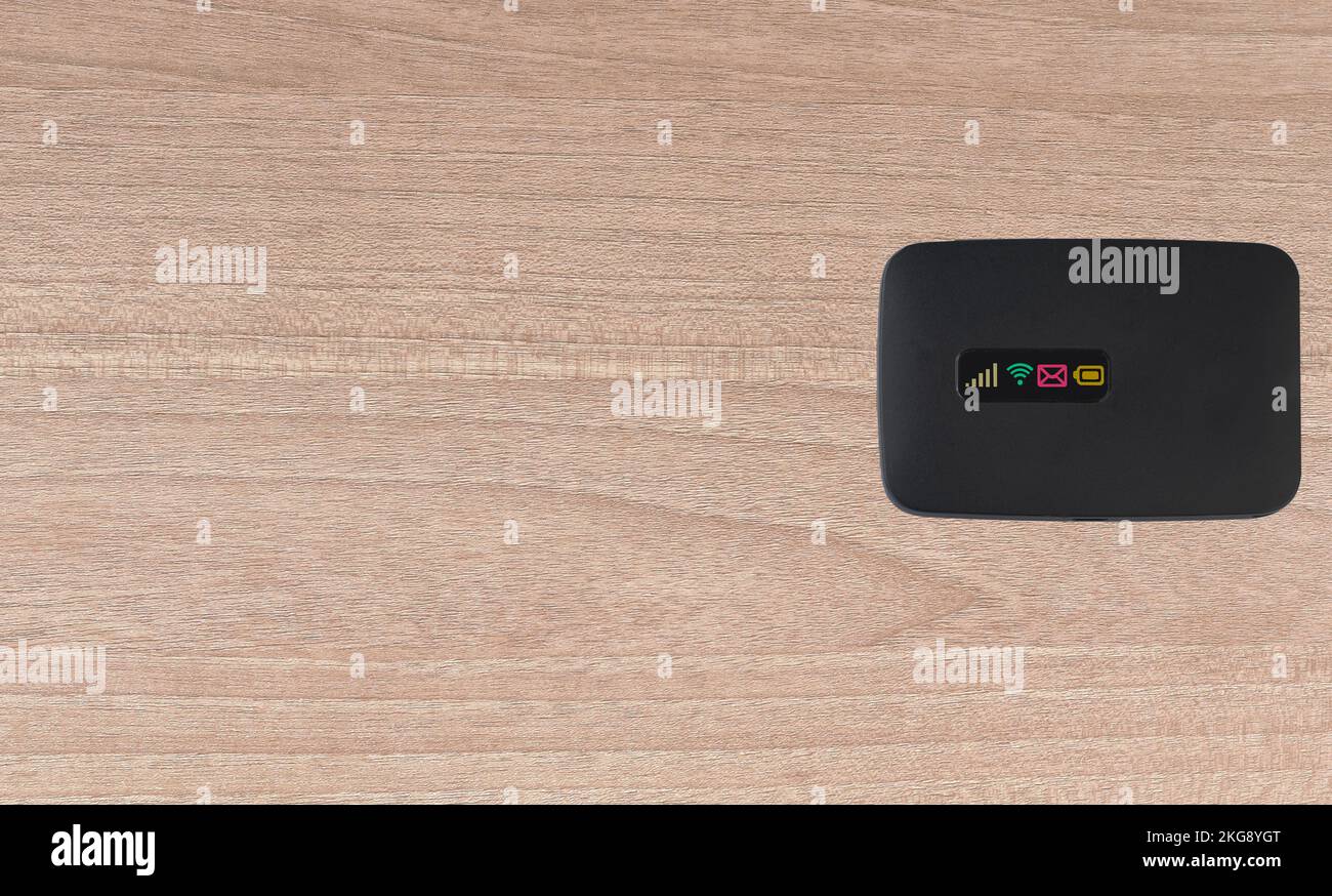 Portable pocket wifi modem on wooden background. black wifi portable ...