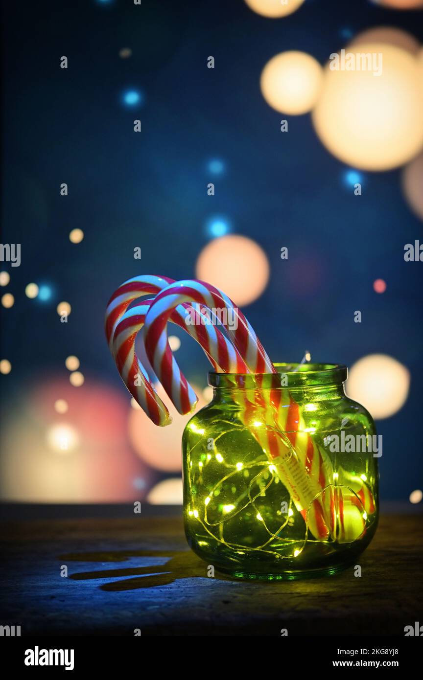 Bunch Of Christmas Candy Canes and Led Light Strips in Old Jar Stock ...