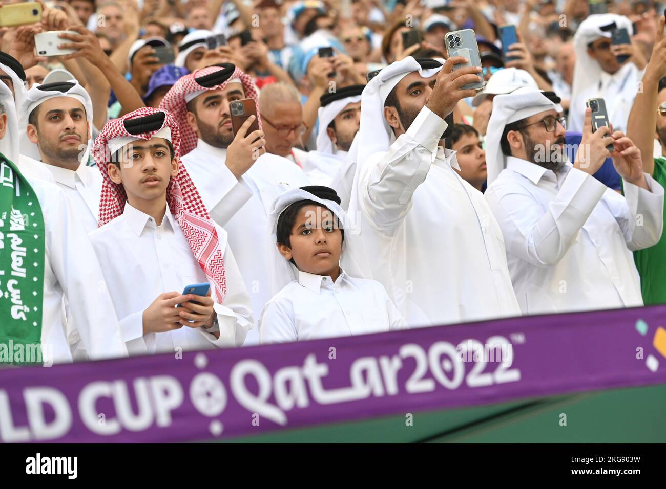 Qatari fans, football fans in traditional robes take photos and films ...