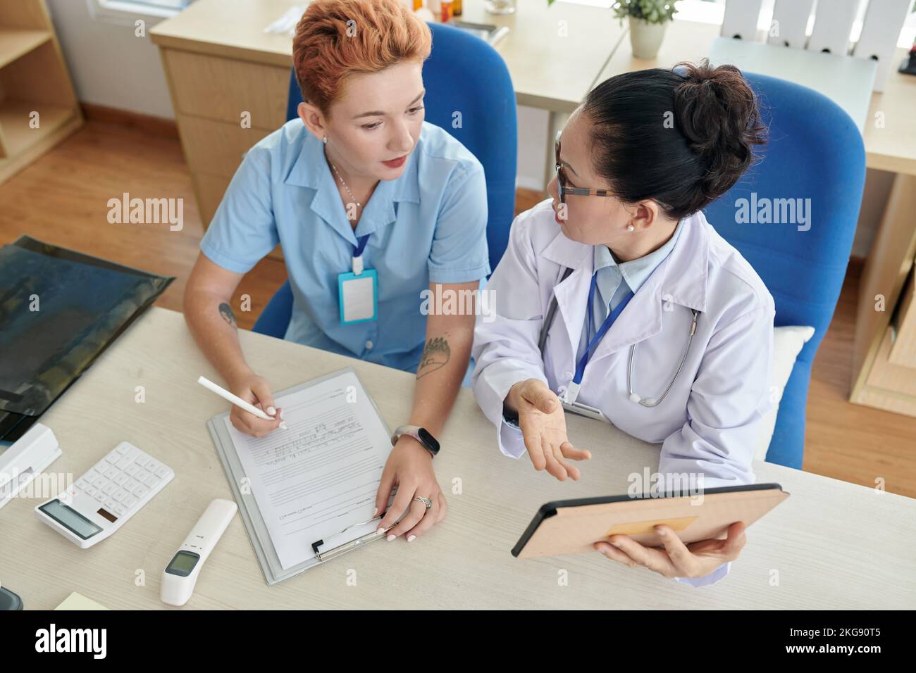 Doctors discussing prescription for new patient after check-up Stock ...