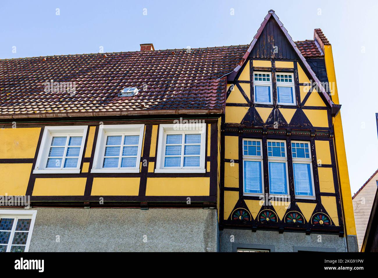 The modern yellow building with a brown roof and glass windows Stock ...