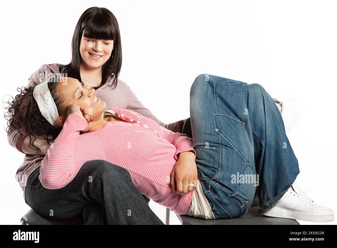 Teenagers: Best Friends. A pair of late teenage friends sitting ...