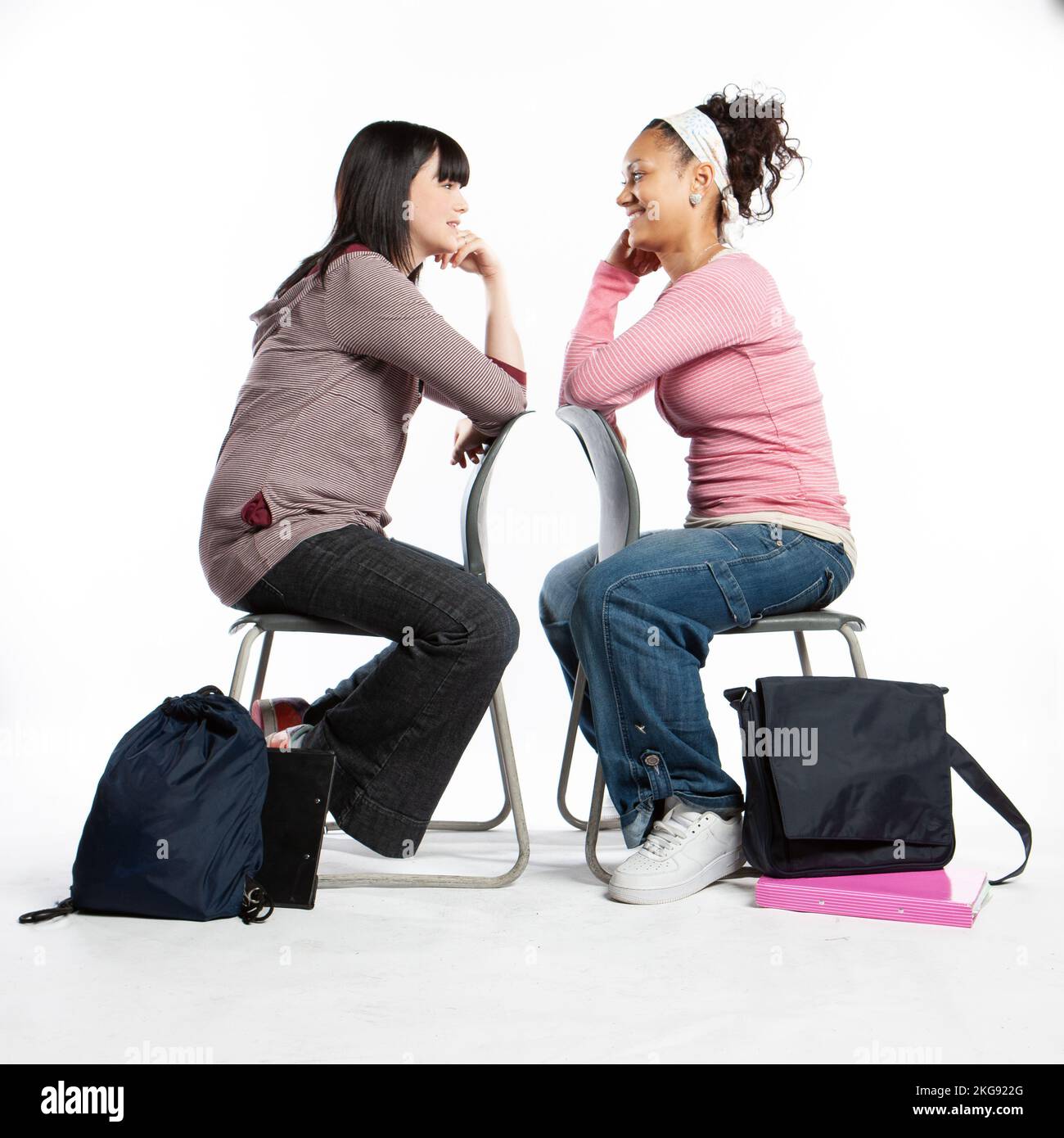 Teenagers: Good Friends. Teenage girls sitting facing each other with ...