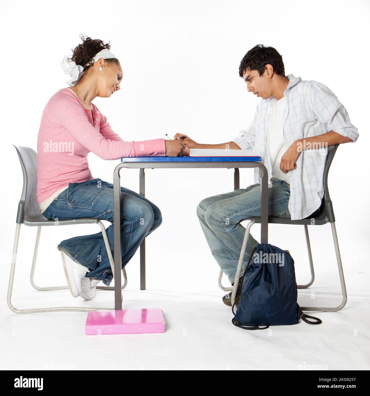 Teenagers: Problem Solving. A pair of late teenage students working on ...
