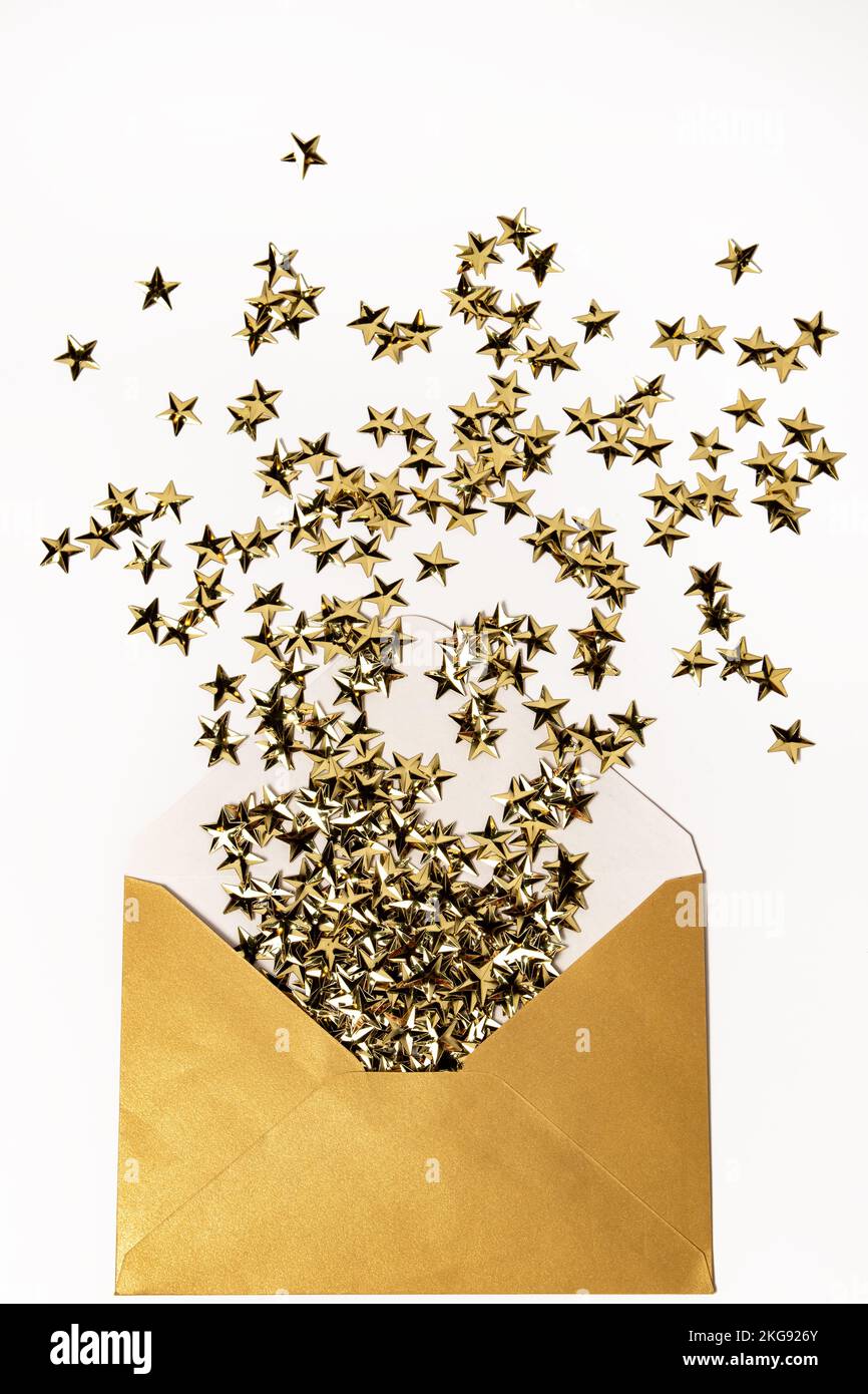 Gold stars spilled from a shiny envelope Stock Photo - Alamy