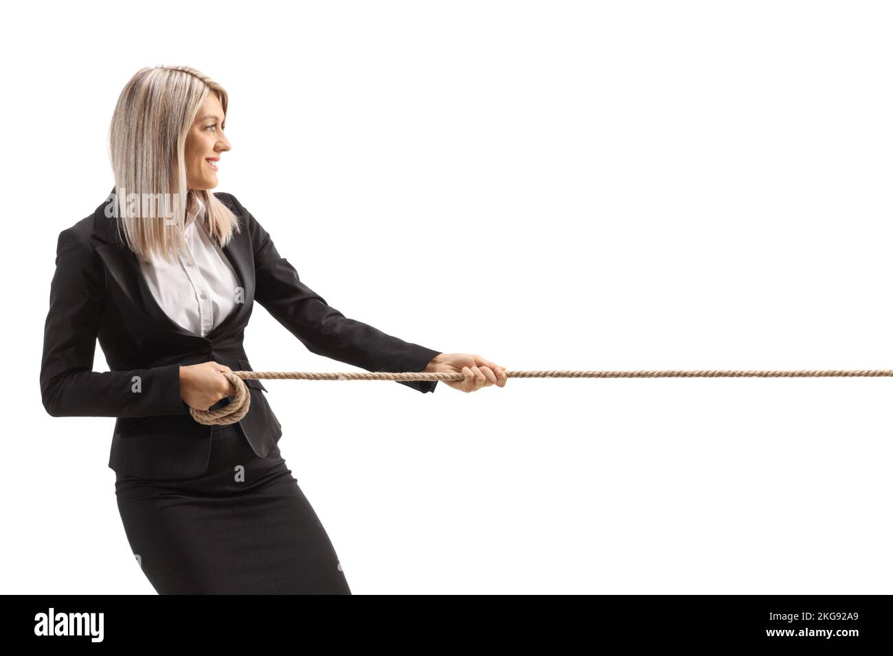 Profile Shot Of A Young Businesswoman Pulling A Rope Isolated On White
