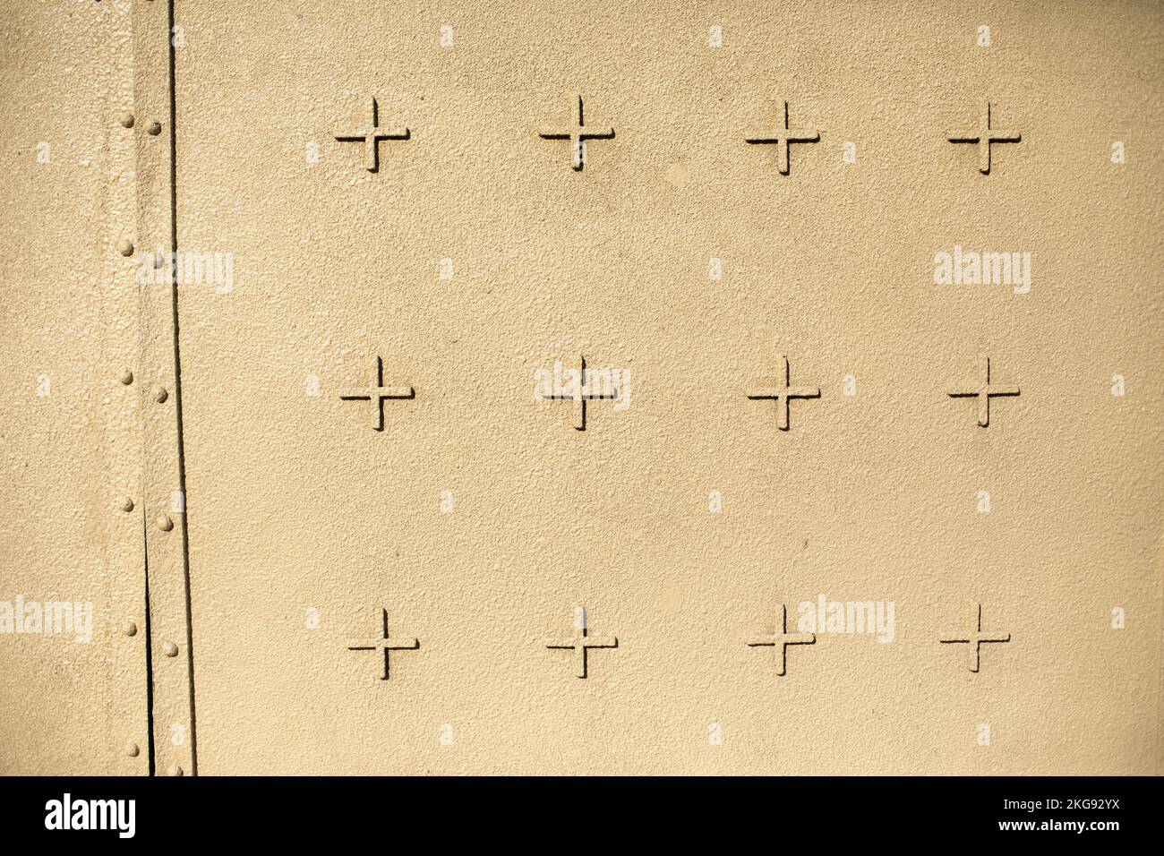 Crosses on wall. Steel wall texture. Surface details in sunlight ...