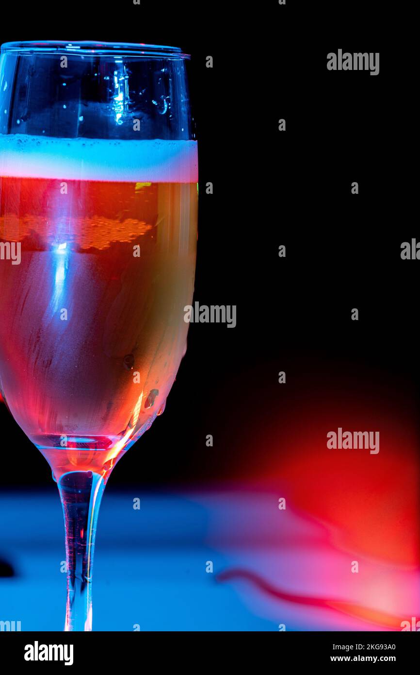 A vertical image of a glass of Champaign in the dark background with ...