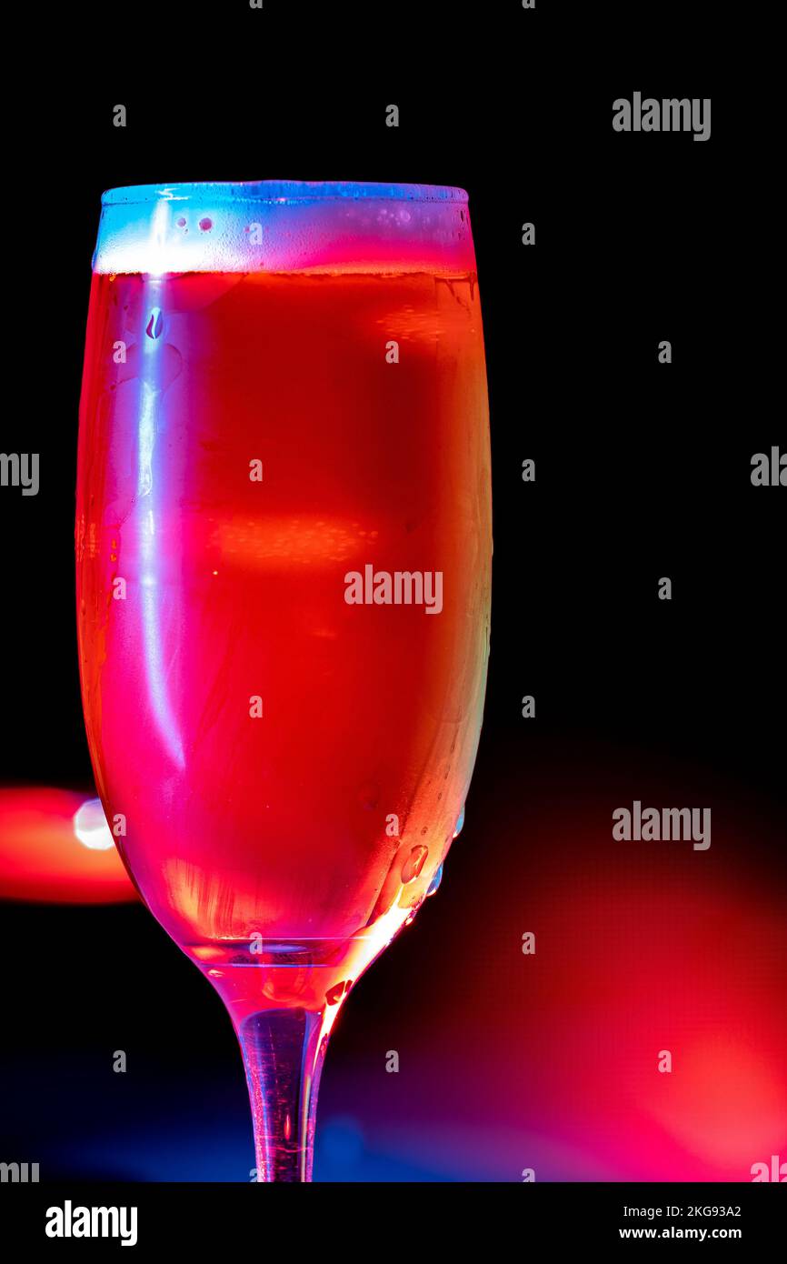 A vertical image of a full glass of Champaign in the dark background ...